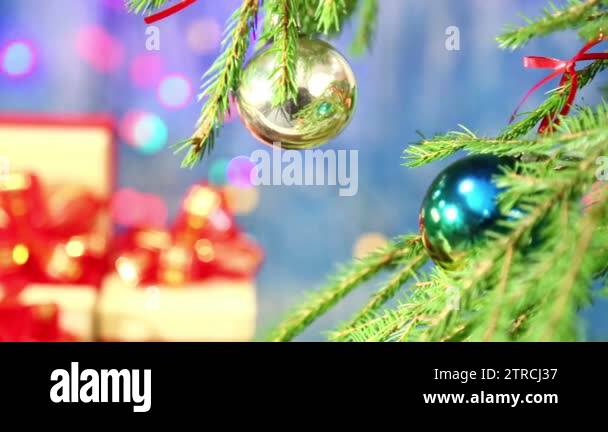 The Christmas tree decorated with balls is blurred and the focus turns ...