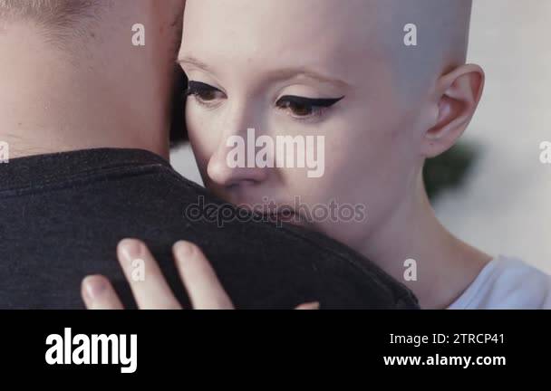 Sad, depressed cancer patient woman hugging her supporting husband ...