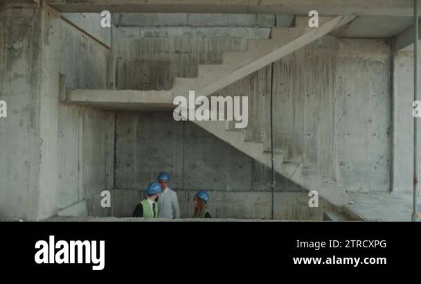 Team of engineers and architects lift up the stairs of construction ...