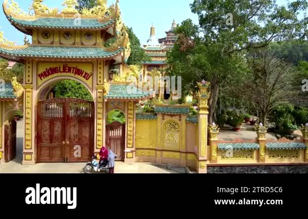 beautiful yellow two-storey gate with dark red door to buddhist temple ...