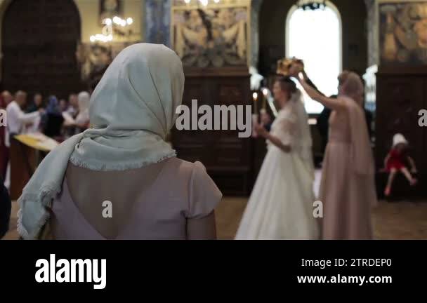 In church orthodox woman cross blessing herself with fingers and bow ...