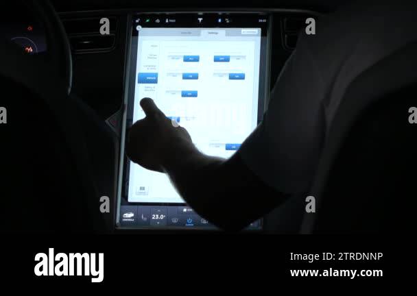 Tesla autonomous car- JULY 10 2016: passenger going through settings on ...