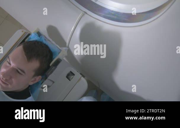 Patient in a Emergency hospital MRI scanner. Man lays in Magnetic ...