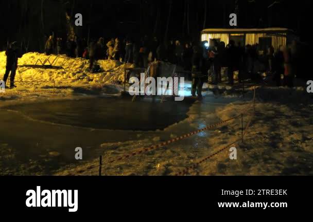 People dip into cold water during celebration of Epiphany, time lapse ...