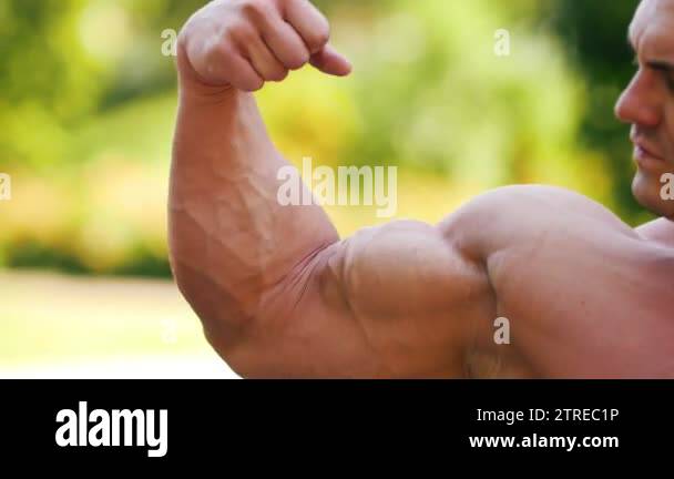 Strong muscular man athlete showing his big bicepses Stock Video ...