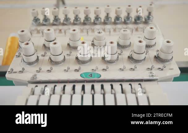 Close-up: automatic sewing machine setting panel. Coils with threads ...