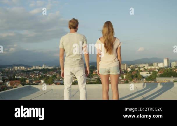 SLOW MOTION CLOSE UP DOF: Caring boyfriend holding girlfriend and kissing her on top of a ...