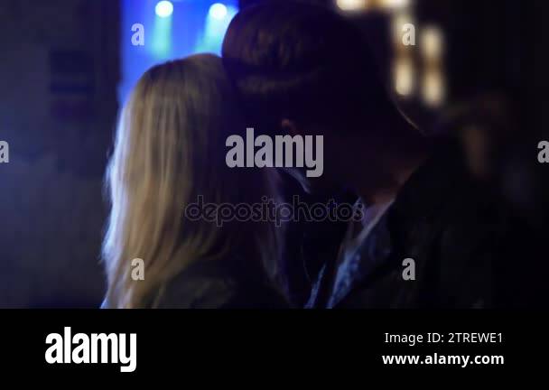 Romantic couple dancing and kissing tenderly on date at night club ...