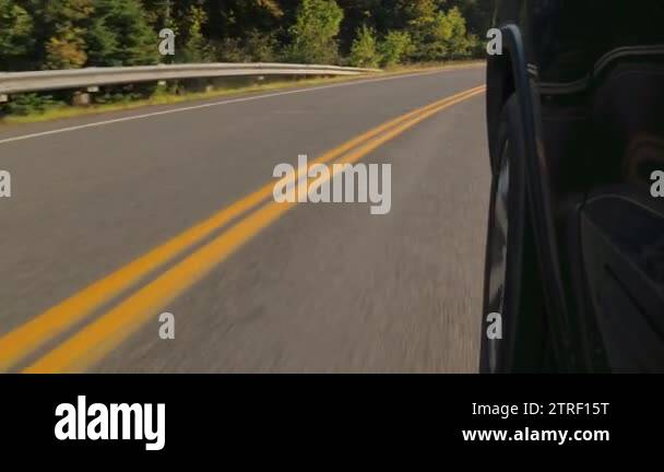 CLOSE UP: Driving on steep road descending from the overgrown mountain ...