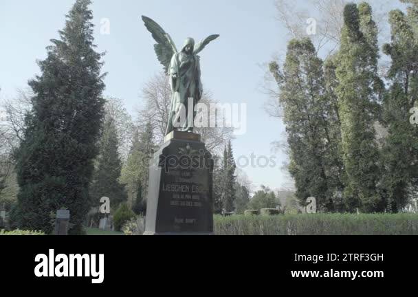Old tombstone from 20th century with an angel on a sunny spring day ...