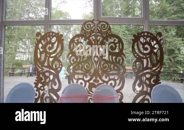 Wedding table at a wedding feast decorated with bridal bouquet. Banquet hall. festive table for ...
