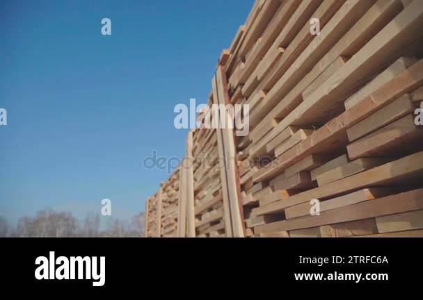 Wooden beams and boards neatly stacked in a pyramid shape Stock Video ...