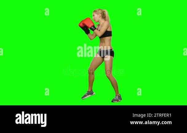 Girl kickboxer in a special form of training for competitions. Green ...