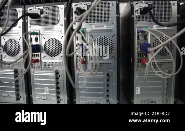 Camera shows grey system units back sides with colored wires ports and ...