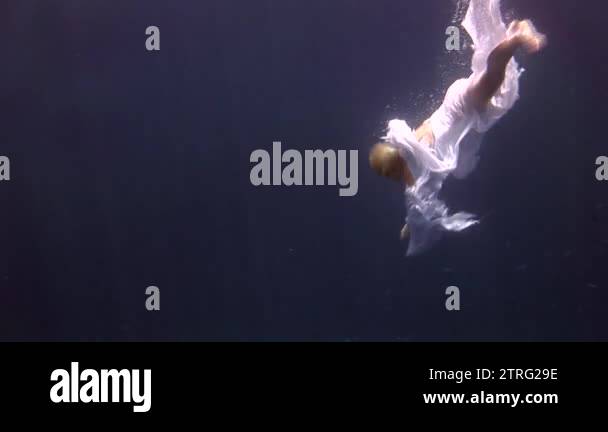 Young girl model free diver underwater white angel costume poses in Red ...