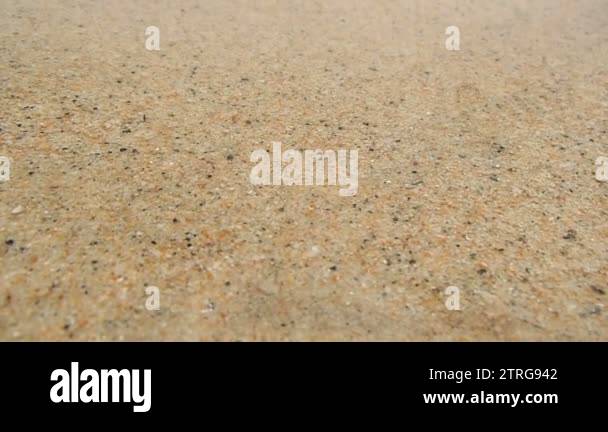 Close up footage of sea surf. Transparent water with floating sand ...