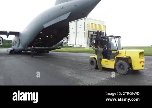Man giving directions for boarding a ground support vehicle on a cargo ...