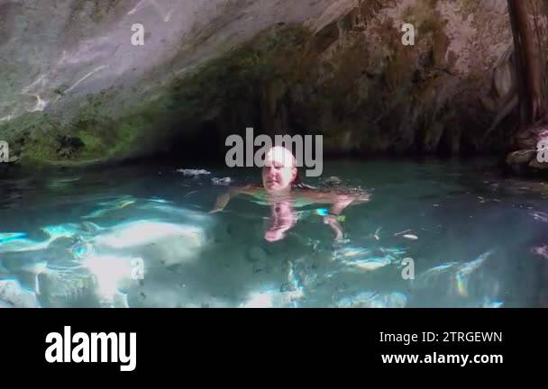 CLOSE UP, SLOW MOTION: Beautiful young woman swimming in fresh river ...