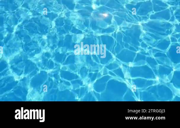 Relaxing swimming pool backdrop shining with see through waters in slo ...