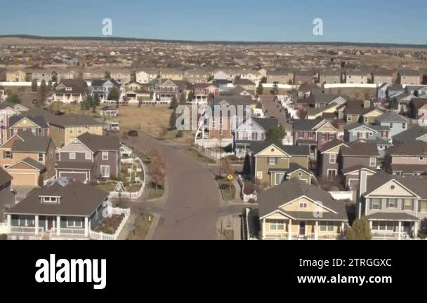 AERIAL CLOSE UP: Flying above the rooftops of new modern expensive row ...