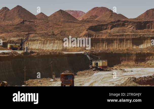 Excavators load ore into dump-trucks. This area has been mined for ...