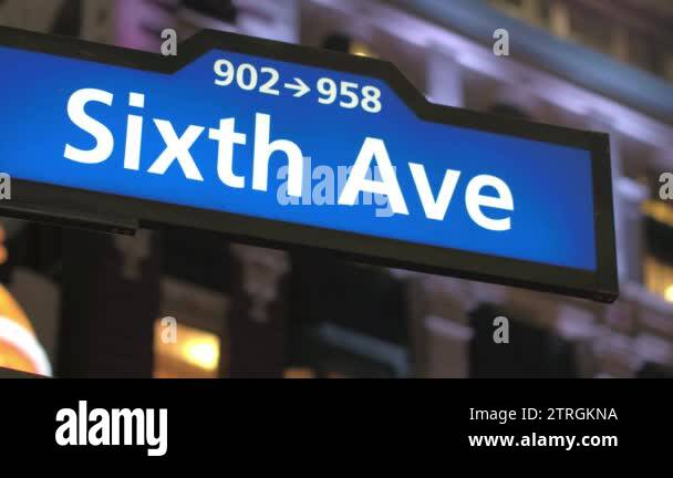 CLOSE UP, DOF: Blue glowing Broadway street sign on the corner against ...