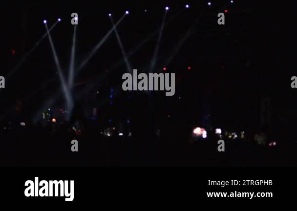 Fantastic light show, illumination flashing on stage, crowd silhouettes ...