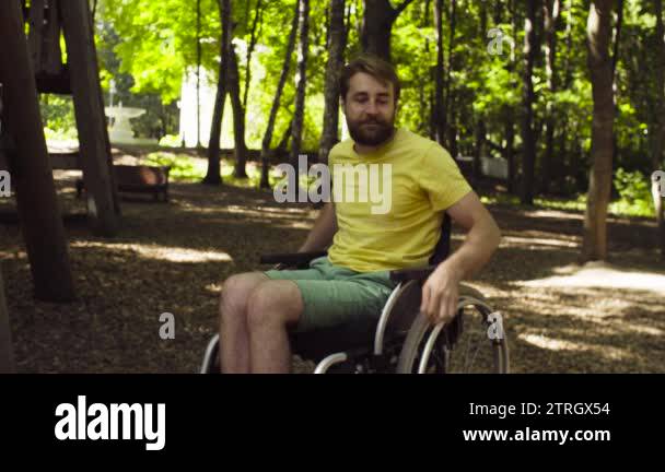 Young disable man with his wife on a walk in the park Stock Video ...