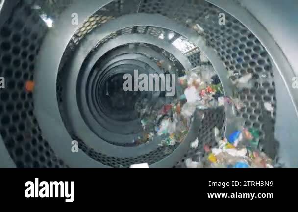 Garbage recycling machine during working process. Garbage sorting plant ...
