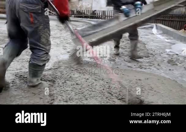 Pouring concrete mix from cement mixer on concreting formwork Stock ...