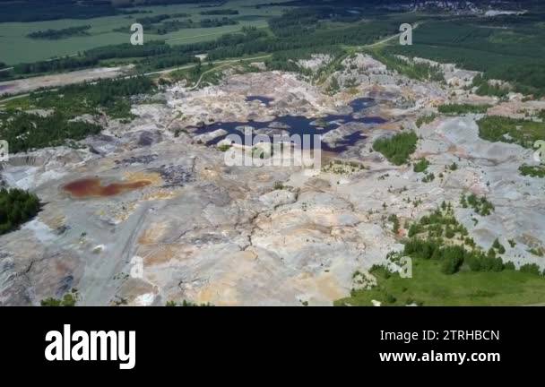 pictorial high general landscape of abandoned huge clay pit with pond ...