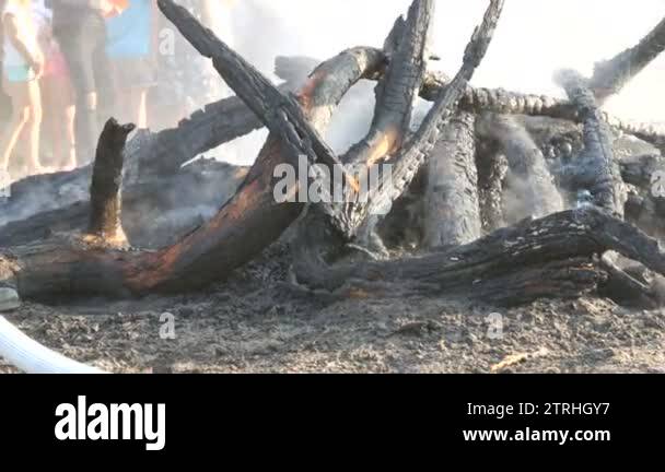 Fireman extinguishes a fire from a fire hose. Burned to the coals ...