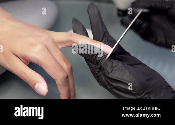 Beautician grinds the nail bar for a manicure in the beauty salon ...