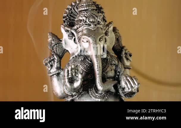 Lord Ganesha and Hinduism. Deity Ganesha with incense. Ganesha as a ...