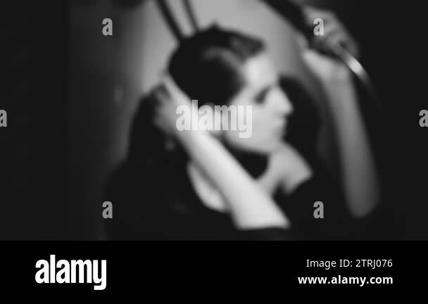 Sad woman crying in shower with water falling on her black and white ...