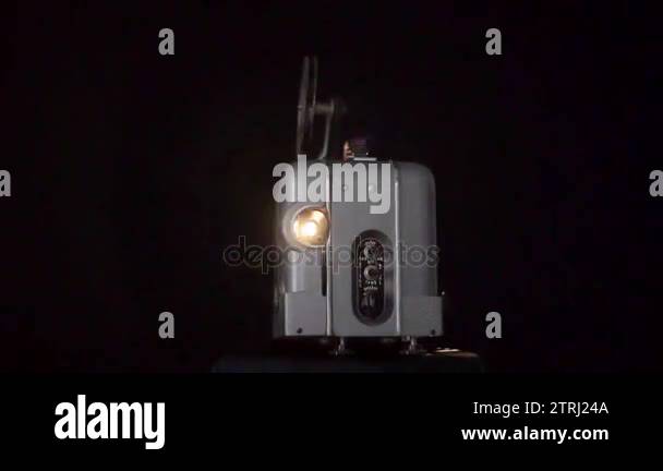 Retro movie projector on a black background. The film 8 millimeters ...