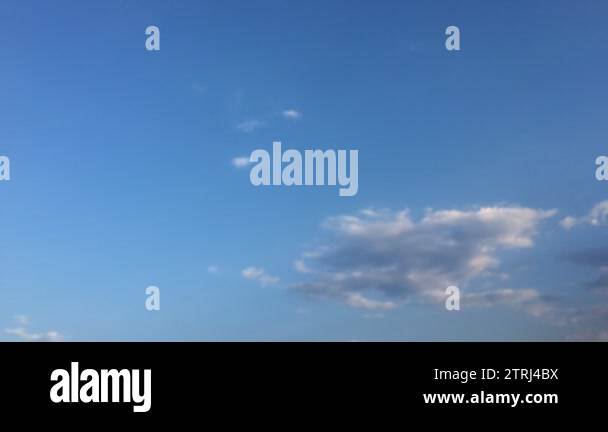 White clouds disappear in the hot sun on blue sky. Loop features time ...