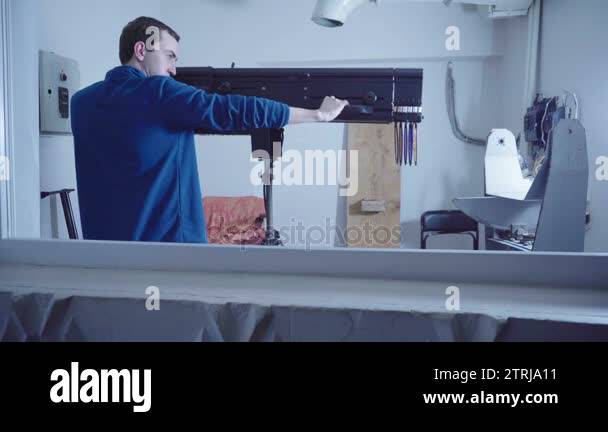 Guy shows a machine gun in a bunker using a follow spot Stock Video ...