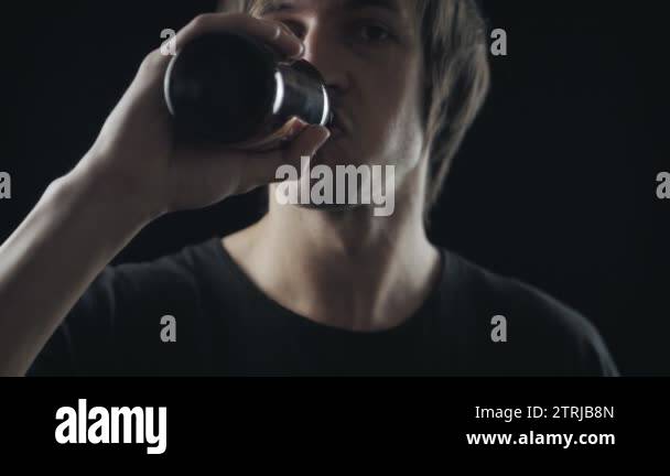 Young man drinking from beer bottle Stock Videos & Footage - HD and 4K Video Clips - Alamy