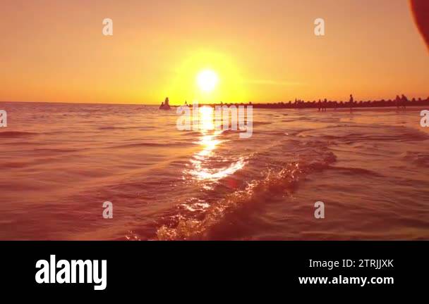 SLOW MOTION, CLOSE UP, SILHOUETTE, LENS FLARE: Detail of female leg ...