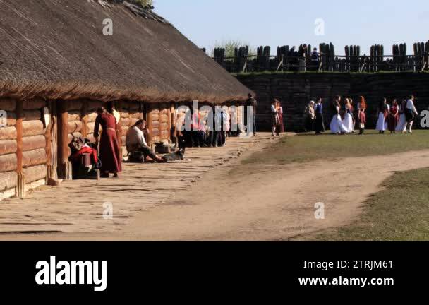 People visit replica of the Iron age fortified settlement in Biskupin ...