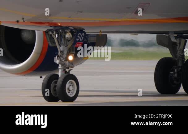 Jet aircraft moves on taxiway at airport. Landing gear, engine and ...