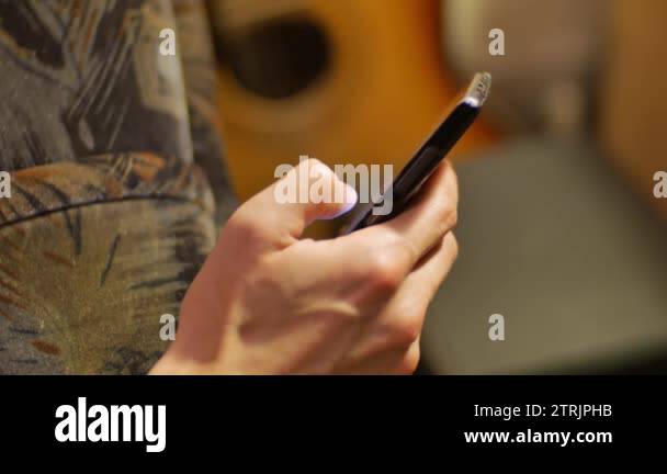 close-up hands using mobile phone touchscreen scroll up and down an ...