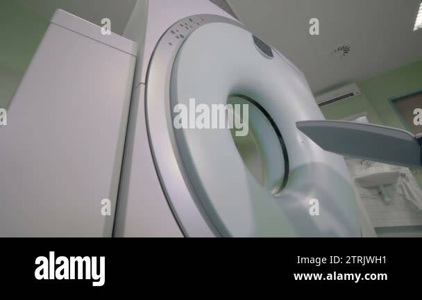 Modern tomography machine works in an empty room. CT scanner. Radiology ...