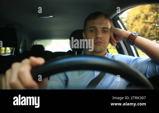 A man drives a car, a man drives in the car through the streets of the ...