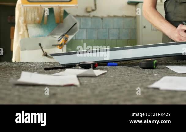 Production and manufacturing of pvc windows, a male worker is measuring ...