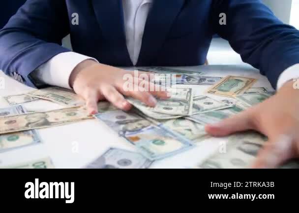 4k footage of greedy young businessman grabbing money lying on desk at ...