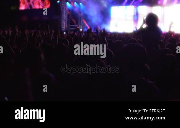 Silhouettes of fans clapping hands at concert, greeting and cheering ...