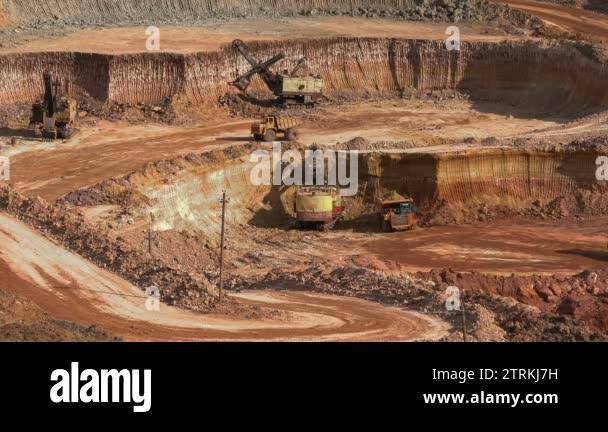 Excavators load ore into dump-trucks. This area has been mined for ...