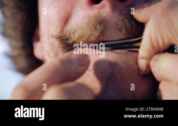 Portrait of a man playing a harp. The bearded shaman plays the ...